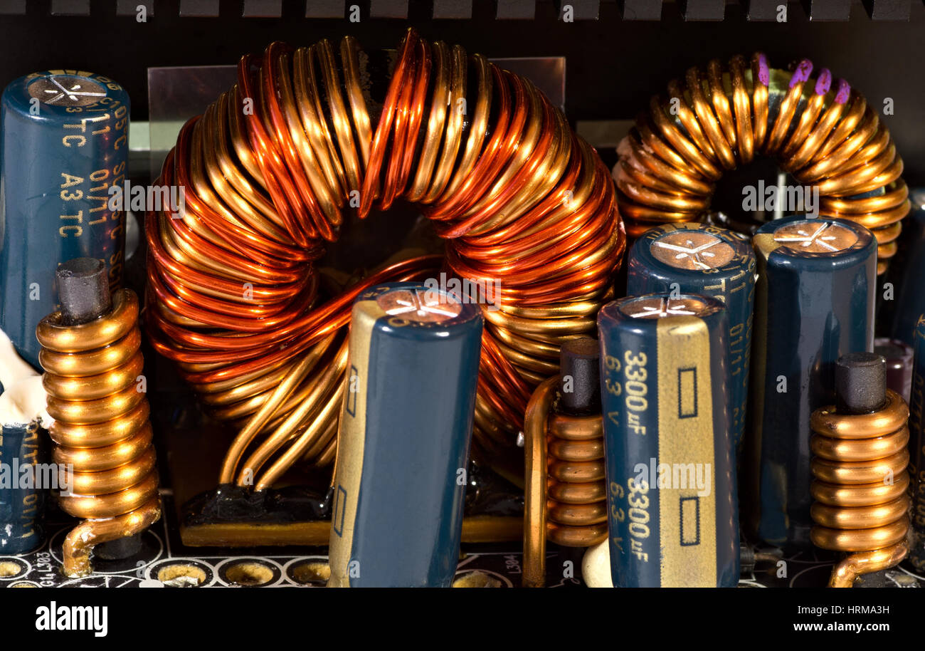 Inductance coil and capacitors in power supply unit Stock Photo - Alamy