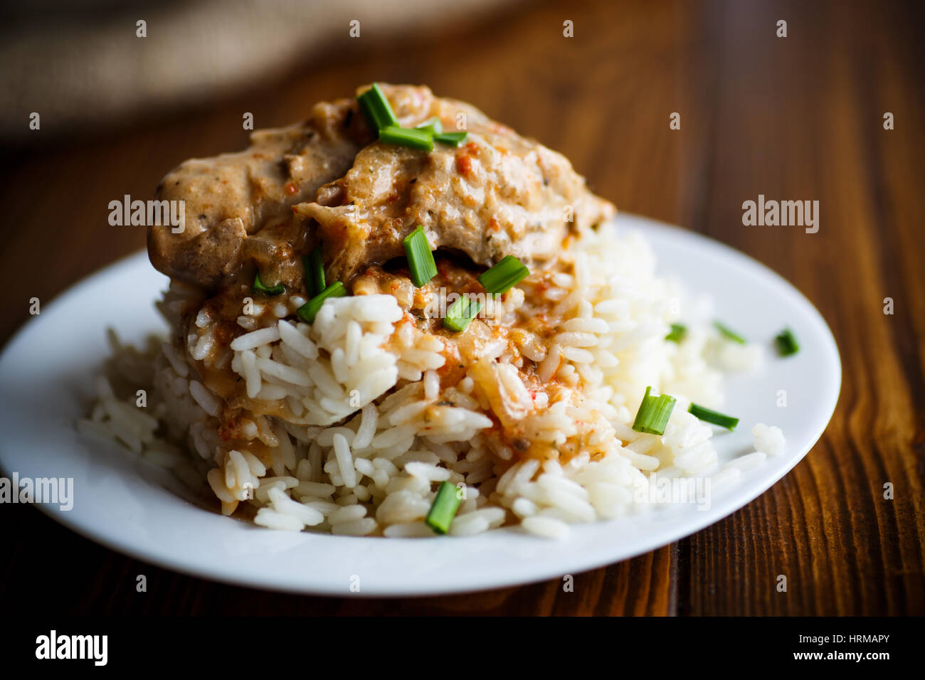 Boiled rice with rabbit meat and sauce Stock Photo - Alamy