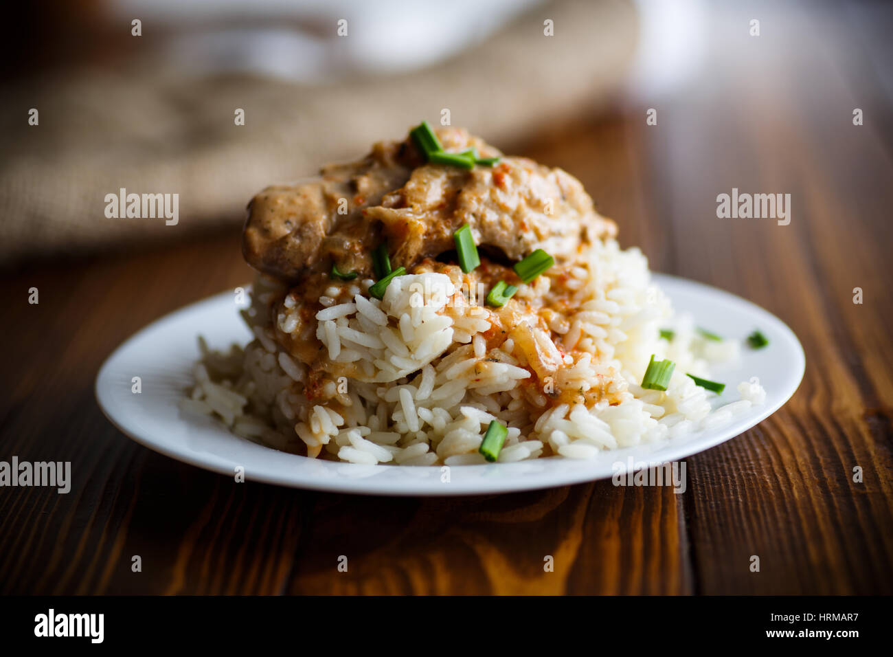 Boiled rice with rabbit meat and sauce Stock Photo - Alamy
