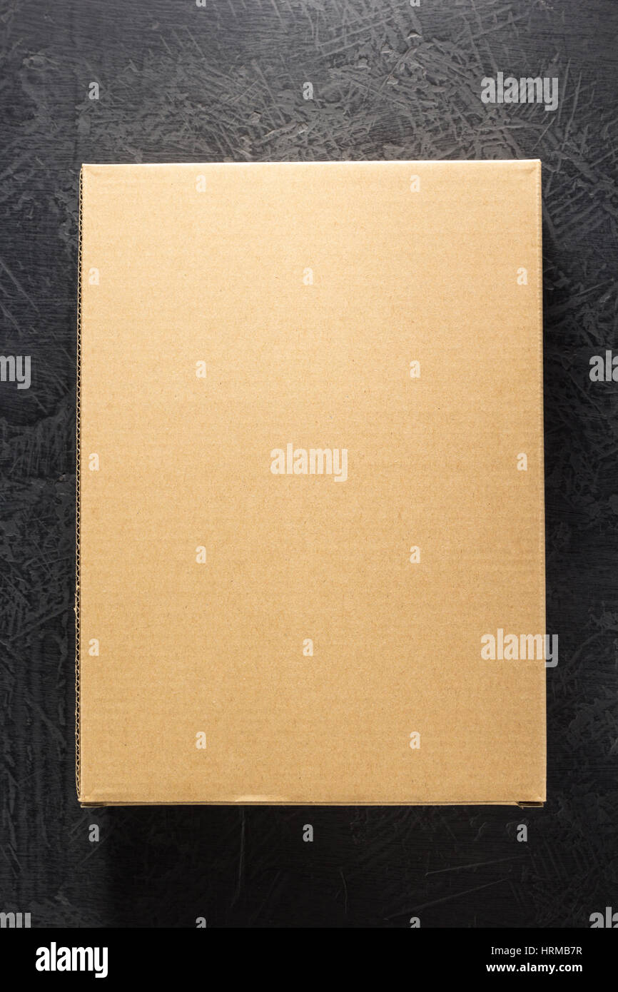 cardboard box on black background surface Stock Photo - Alamy
