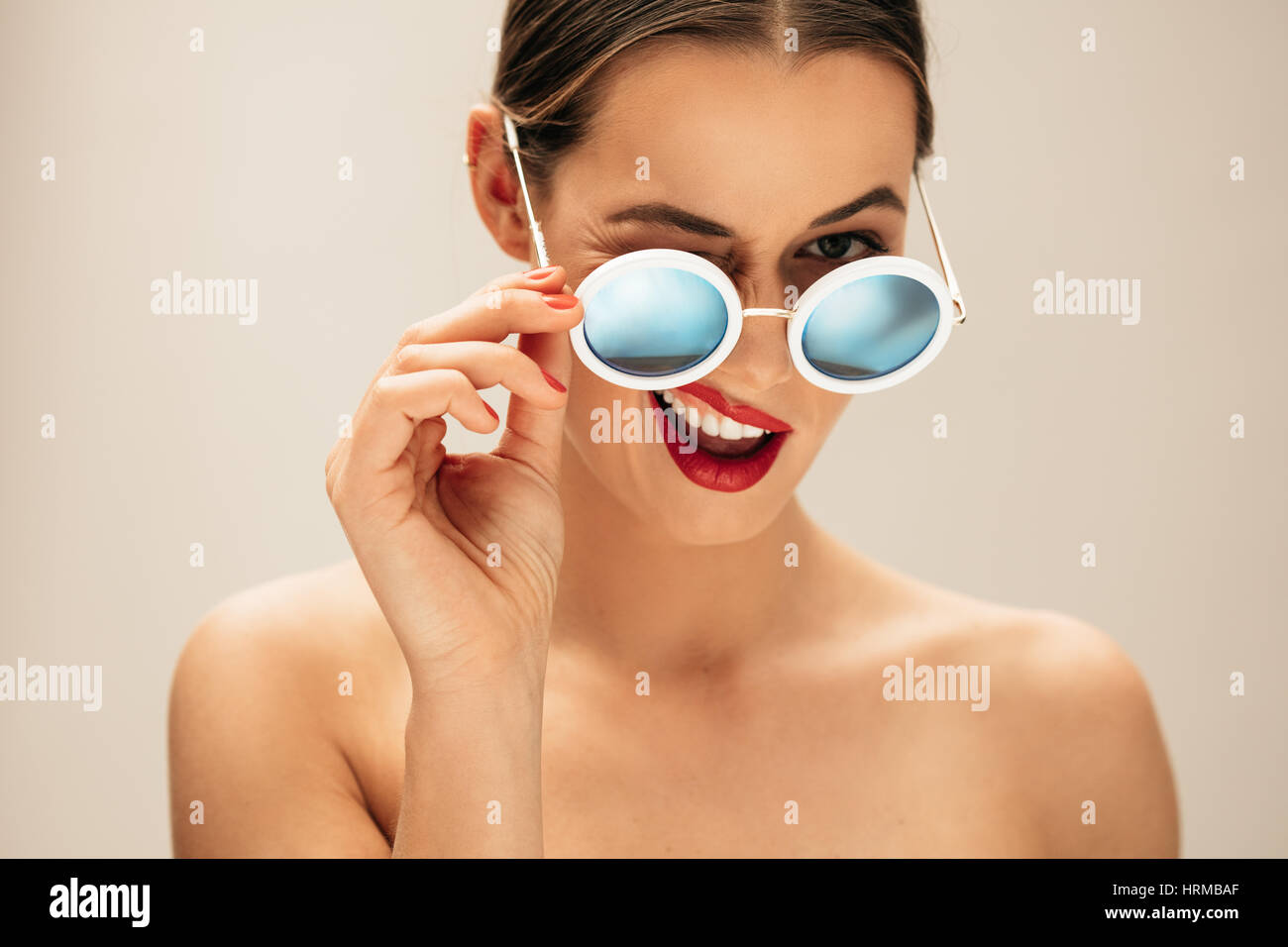 Portrait of beautiful young woman with sunglasses. Female fashion model ...