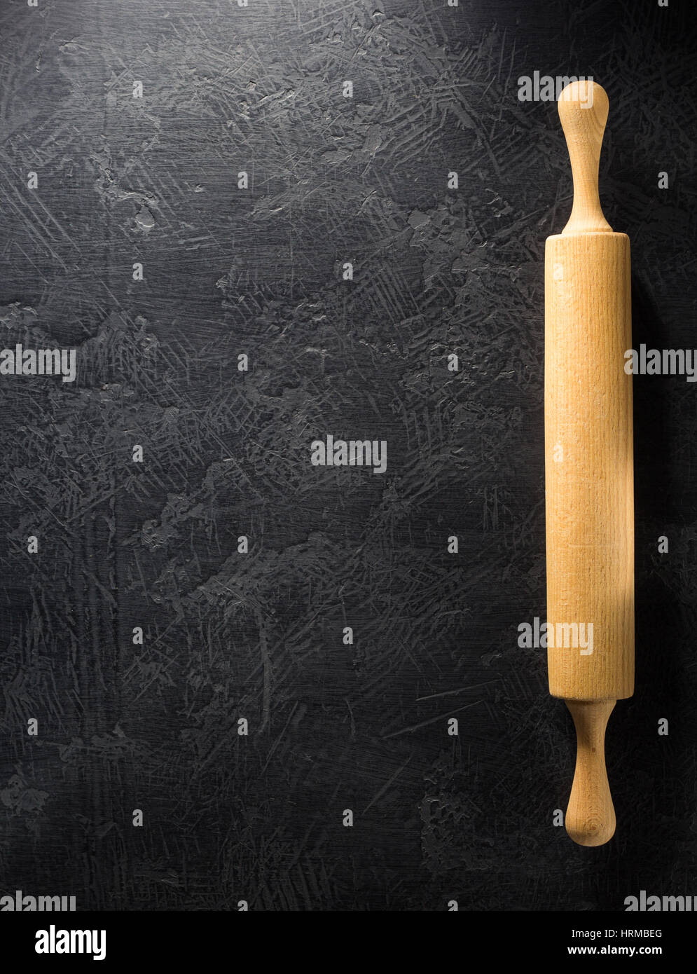 rolling pin at black background texture Stock Photo - Alamy