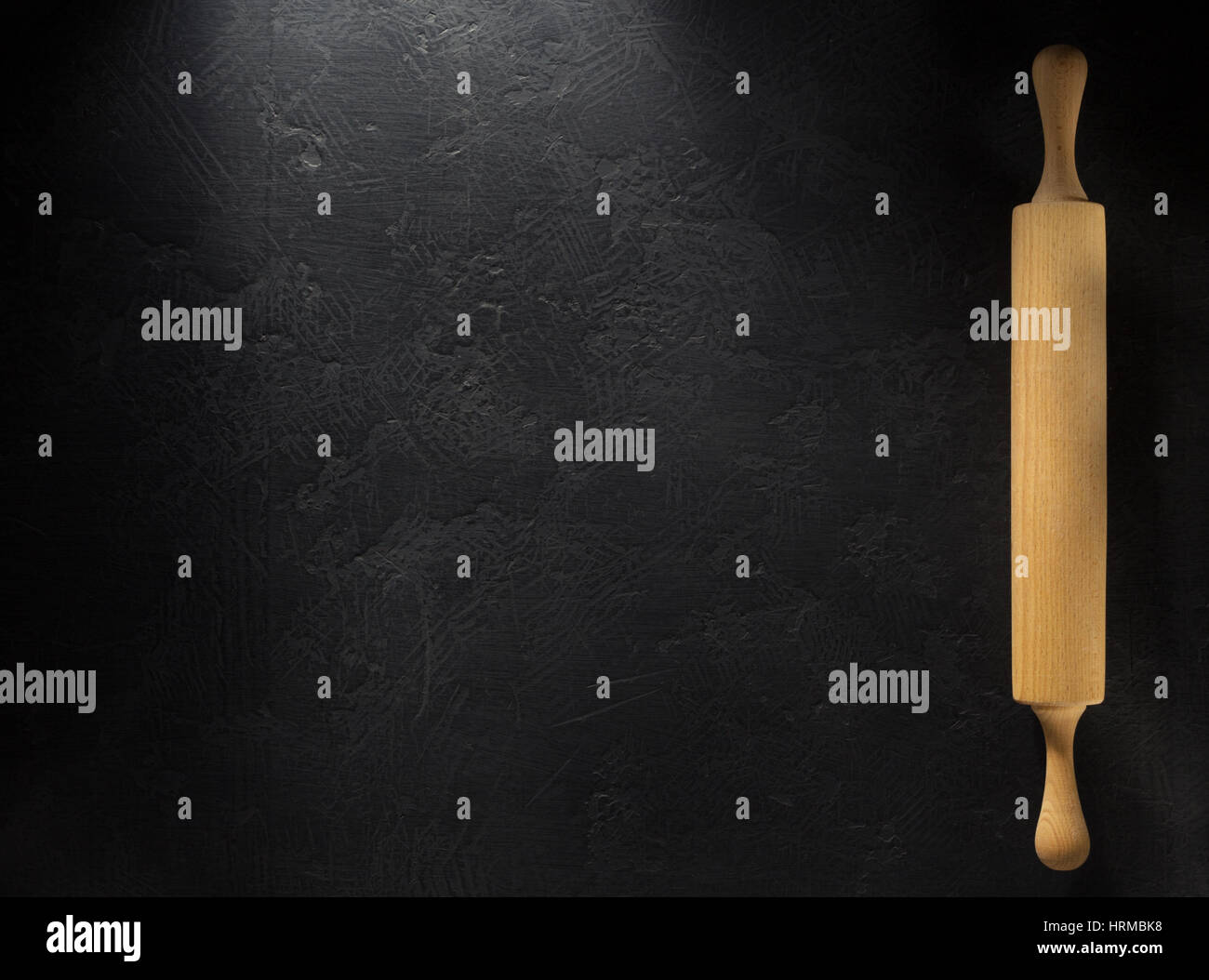 rolling pin on black background texture Stock Photo - Alamy