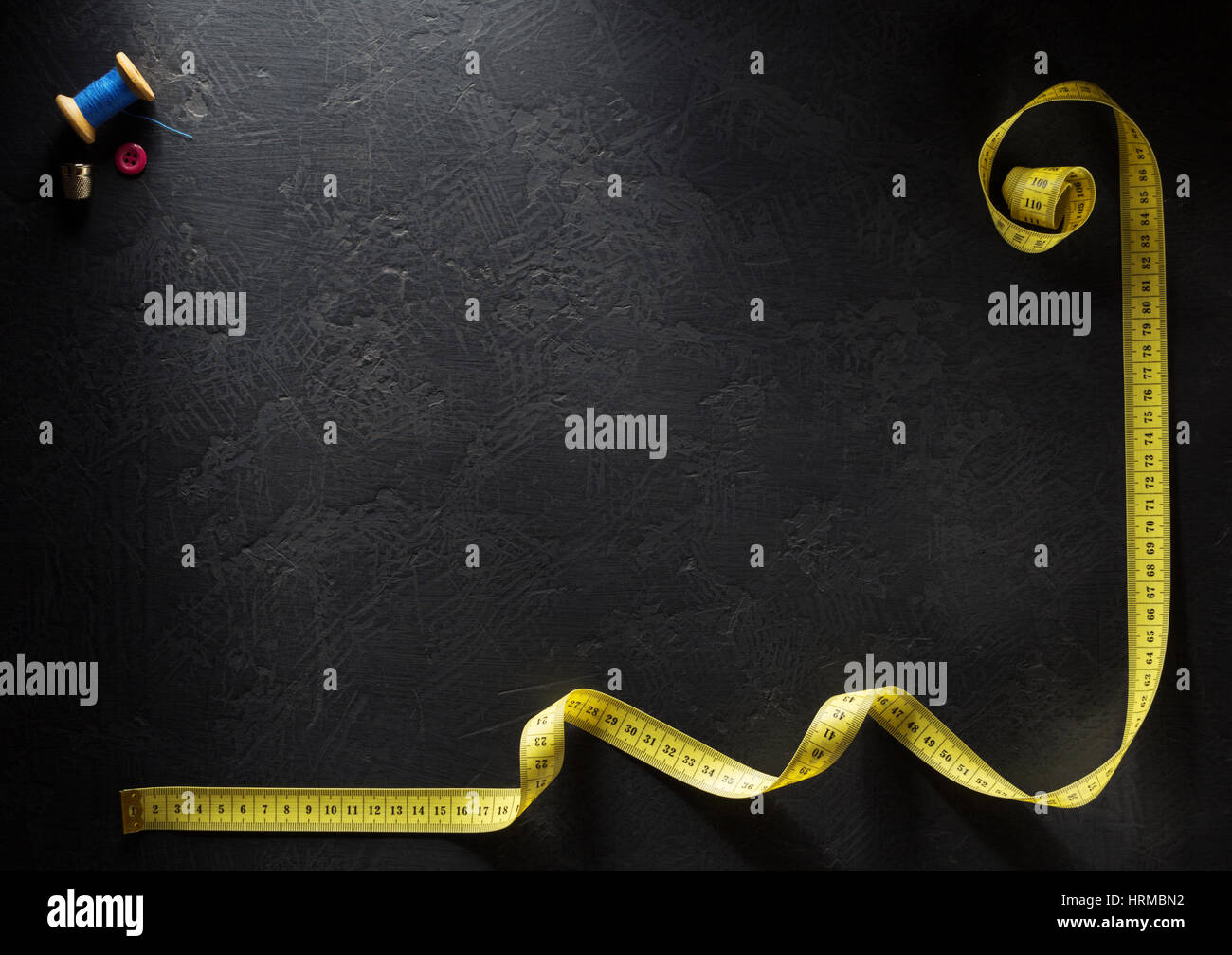 tape measuring on black background texture Stock Photo - Alamy