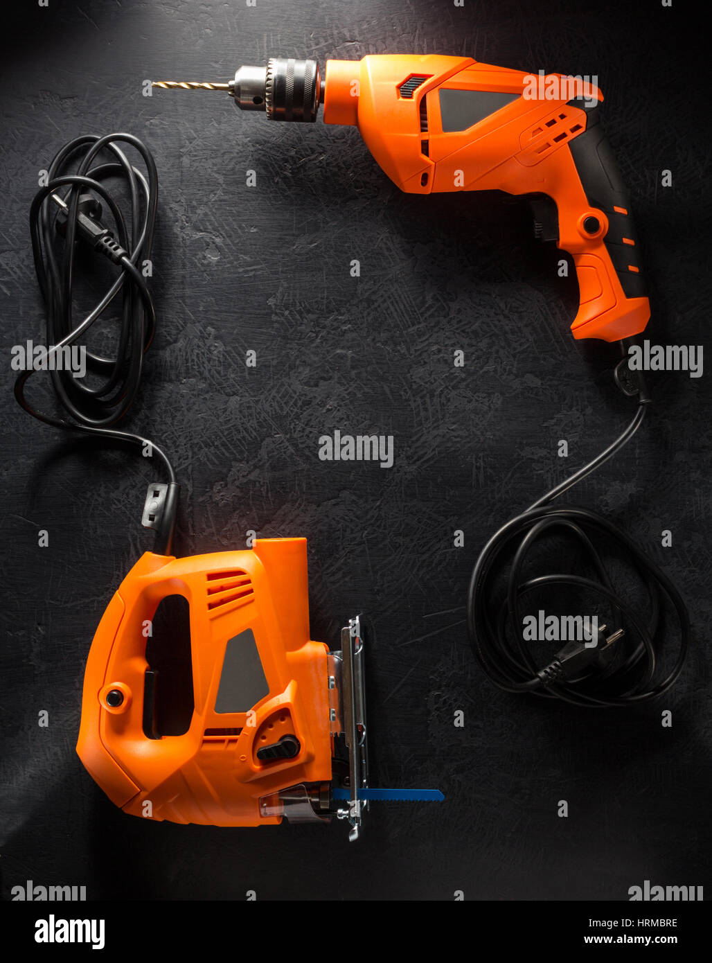 electric tools with cord on black background Stock Photo - Alamy