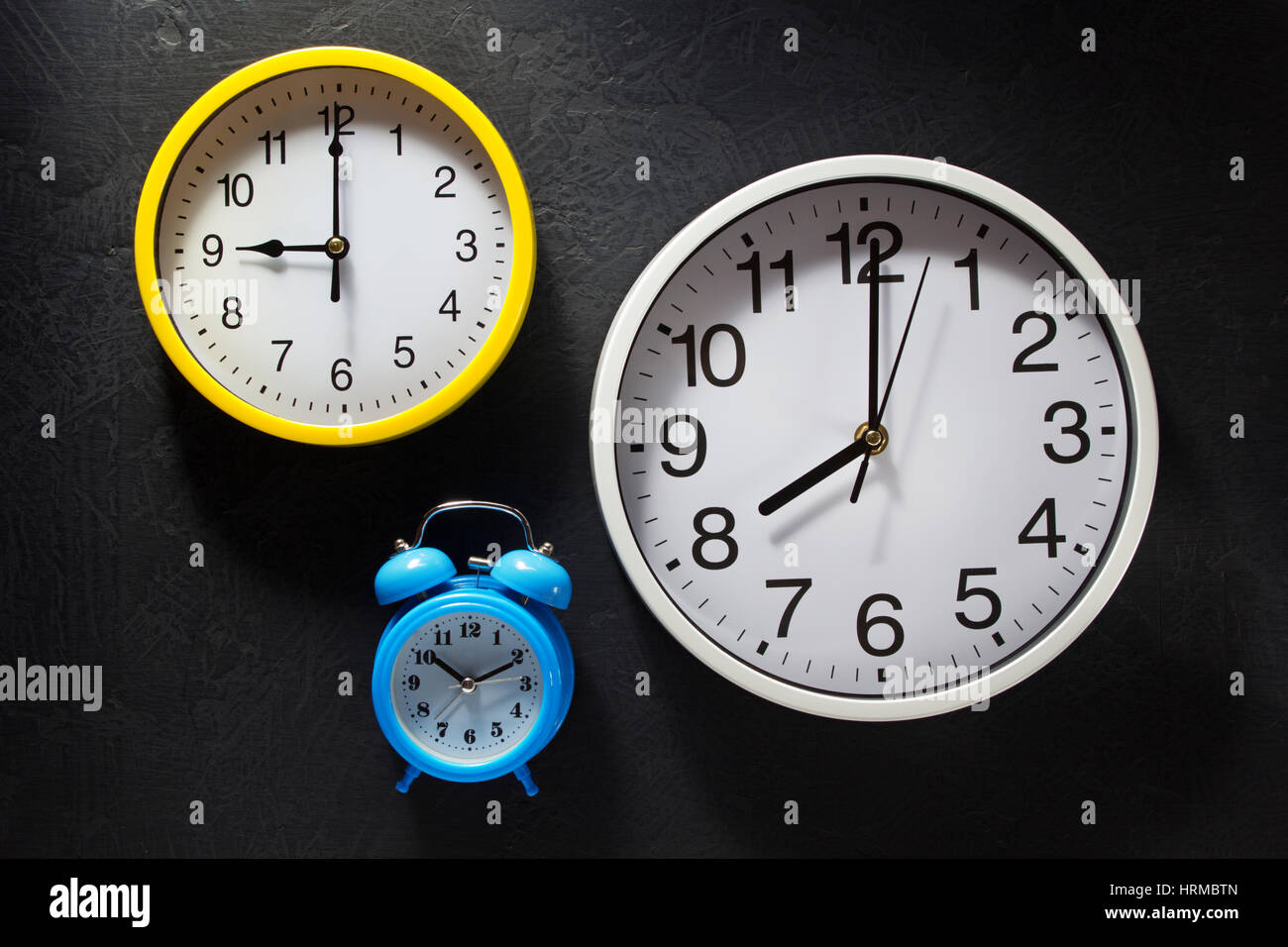 wall and alarm clock at black background texture Stock Photo - Alamy