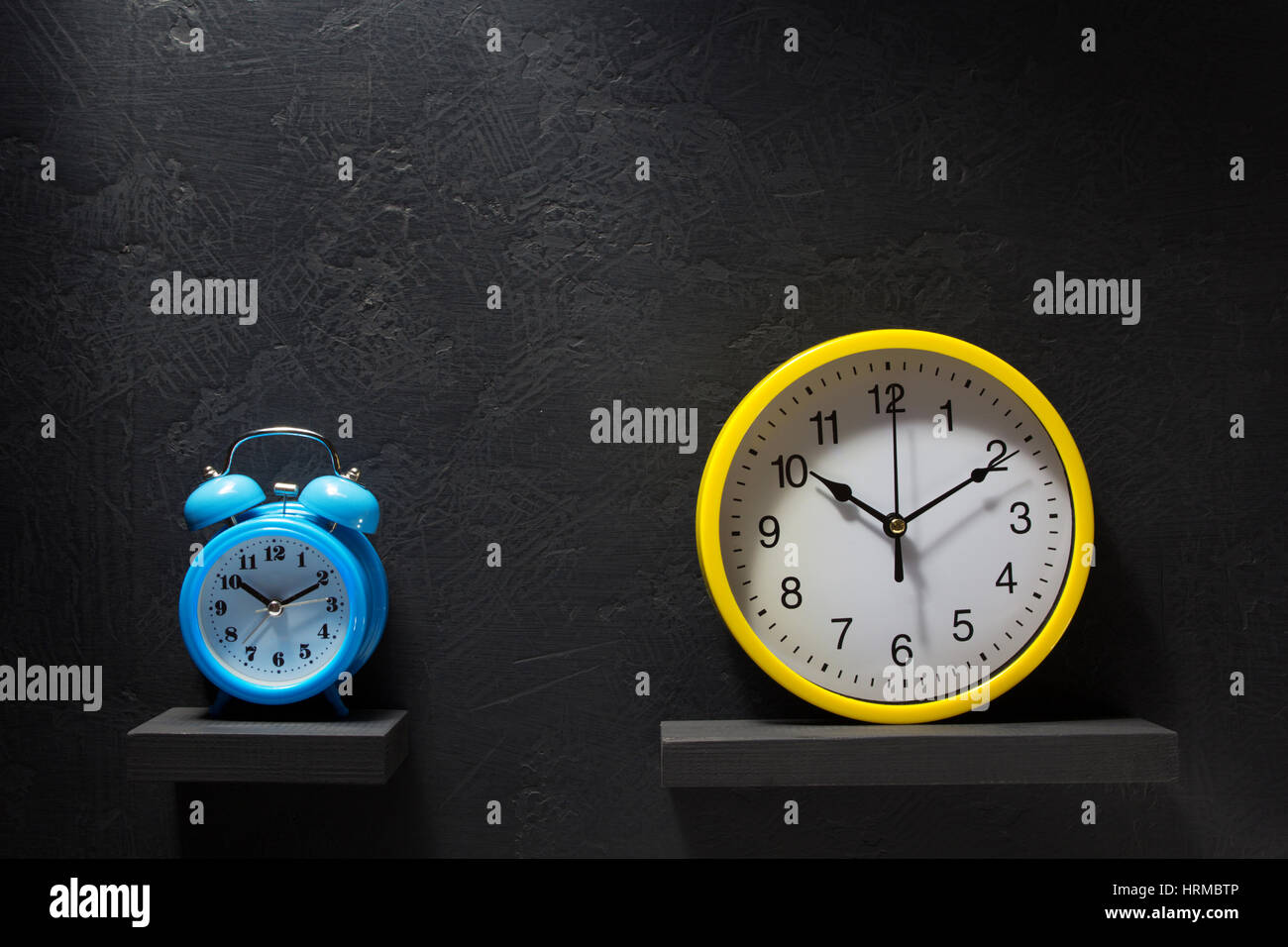 wall and alarm clock at black background texture Stock Photo - Alamy