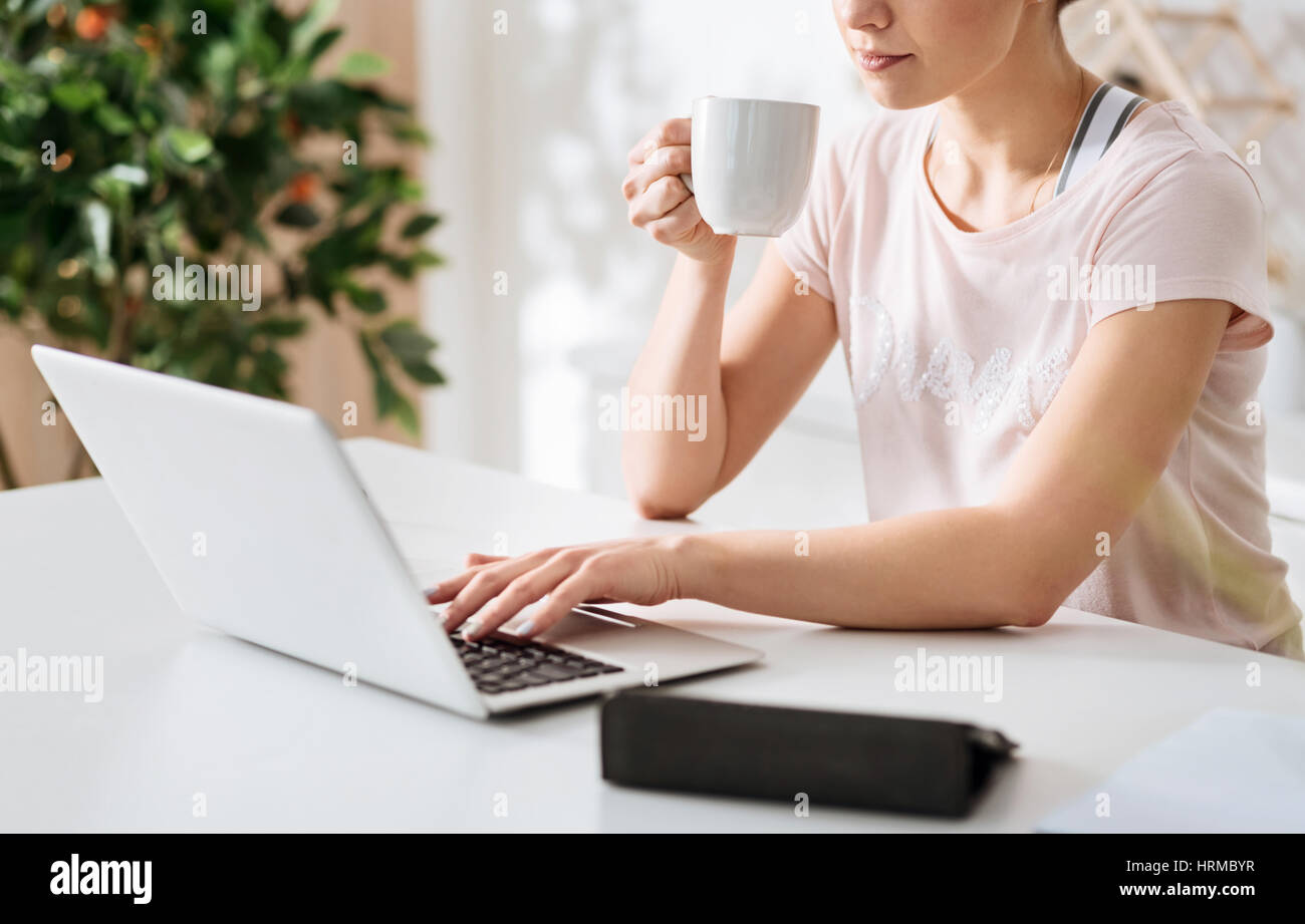 Concentrated elegant woman reading something on her computer Stock ...