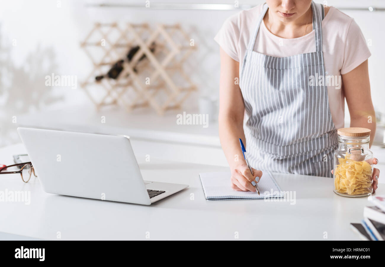 Young housewife writing down ingredients Stock Photo - Alamy