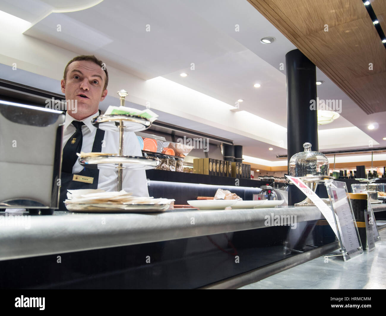 Barman at traditional bar and grocery store Peck near Piaza Duomo in ...