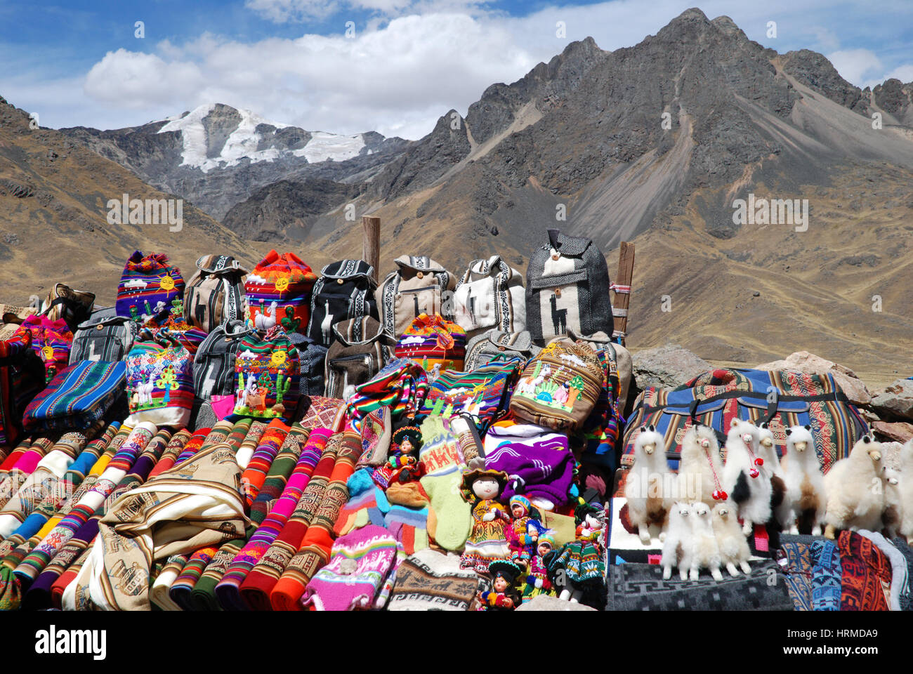 Colorful Peruvian handicrafts on display with an impressive mountain in ...