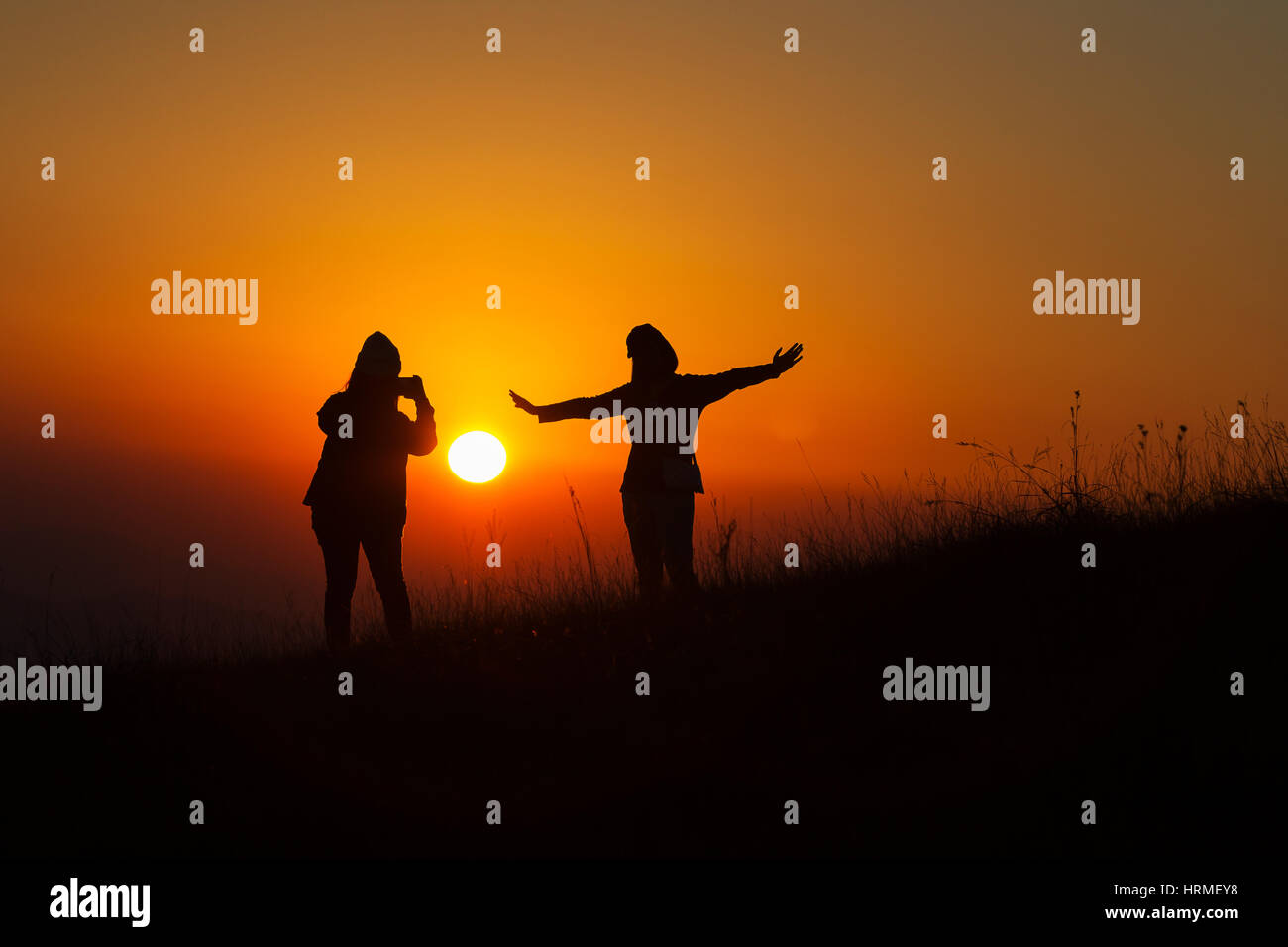 Silhouette Of People having fun at sunset time Stock Photo - Alamy