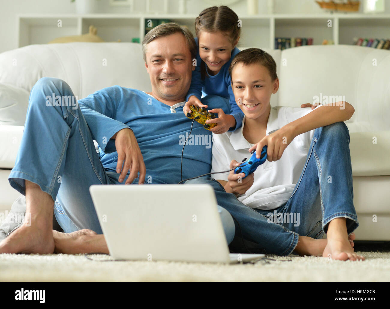 father with kids playing computer games at home Stock Photo - Alamy
