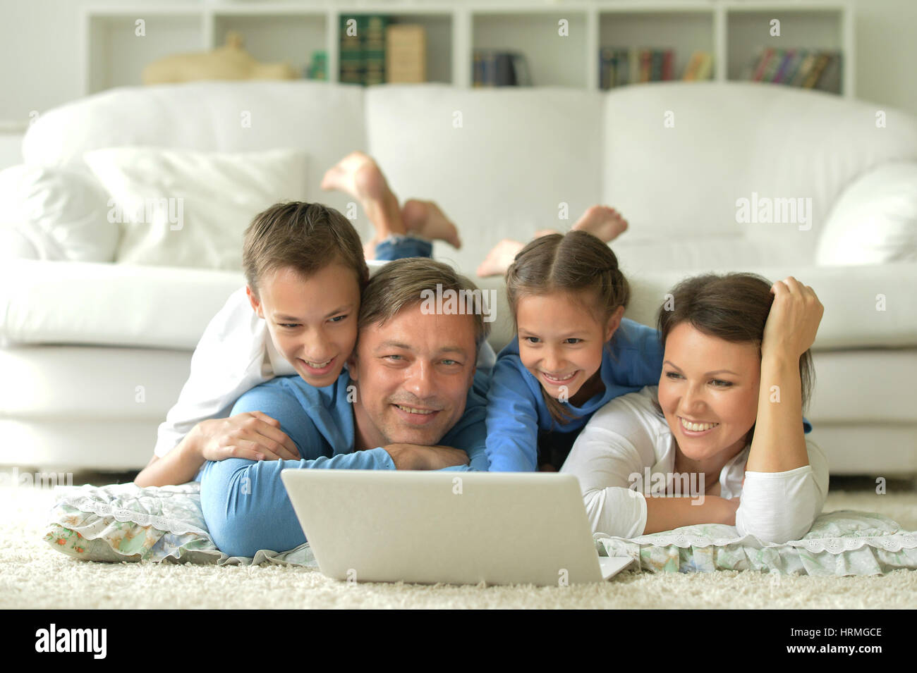 big happy family watching something on laptop Stock Photo - Alamy
