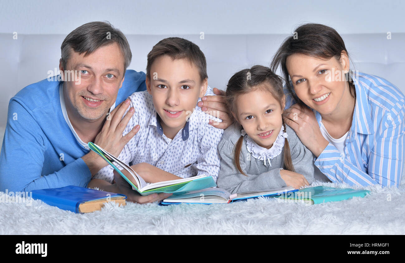 family reading books together on the floor Stock Photo - Alamy