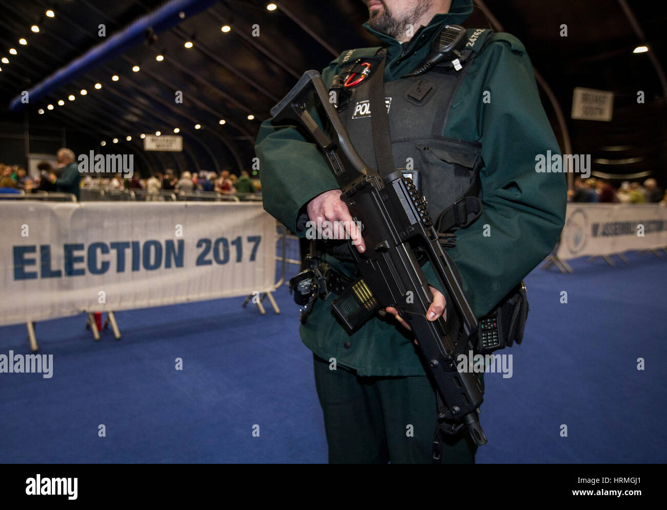 A PSNI officer patrols as election count staff count ballot papers at ...
