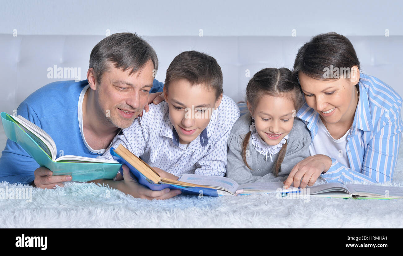 family reading books together on the floor Stock Photo - Alamy