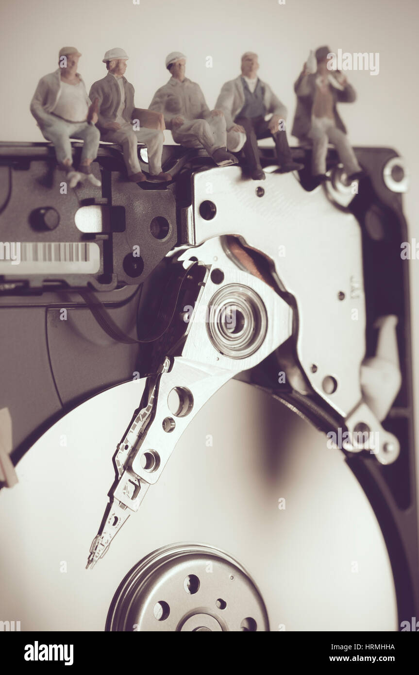 Construction workers on a break on top of giant hard drive. Technology ...
