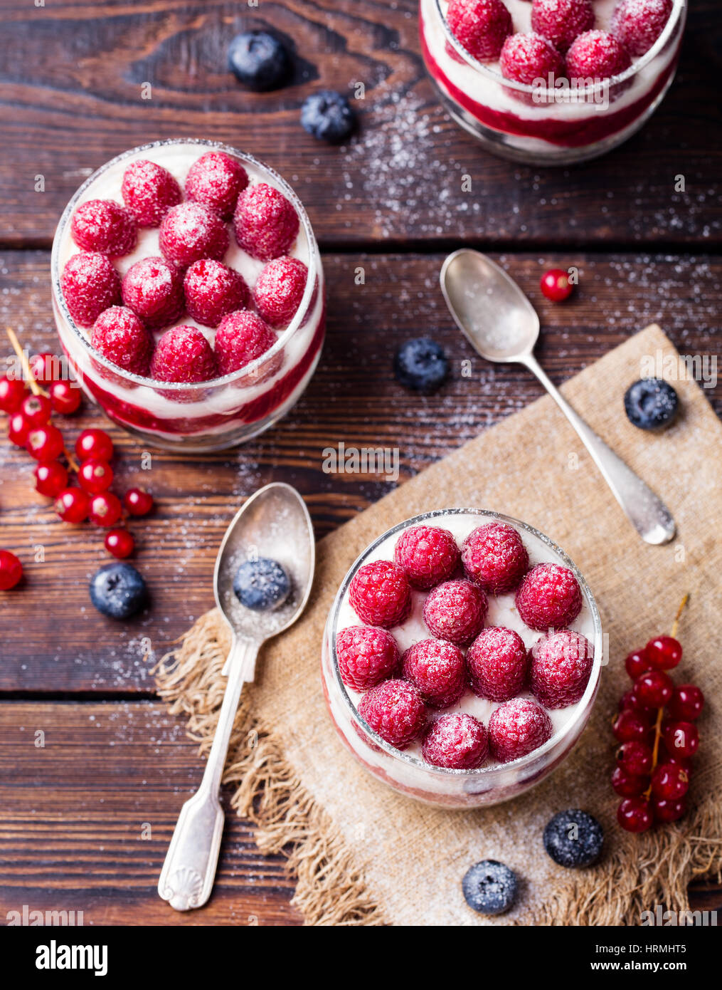Raspberry dessert, cheesecake, trifle, mouse in a glass on a wooden ...