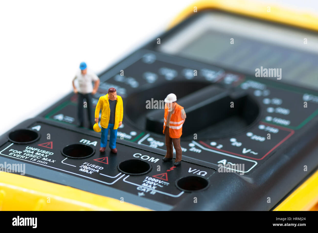 Miniature workers on top of multimeter. Macro photo Stock Photo - Alamy