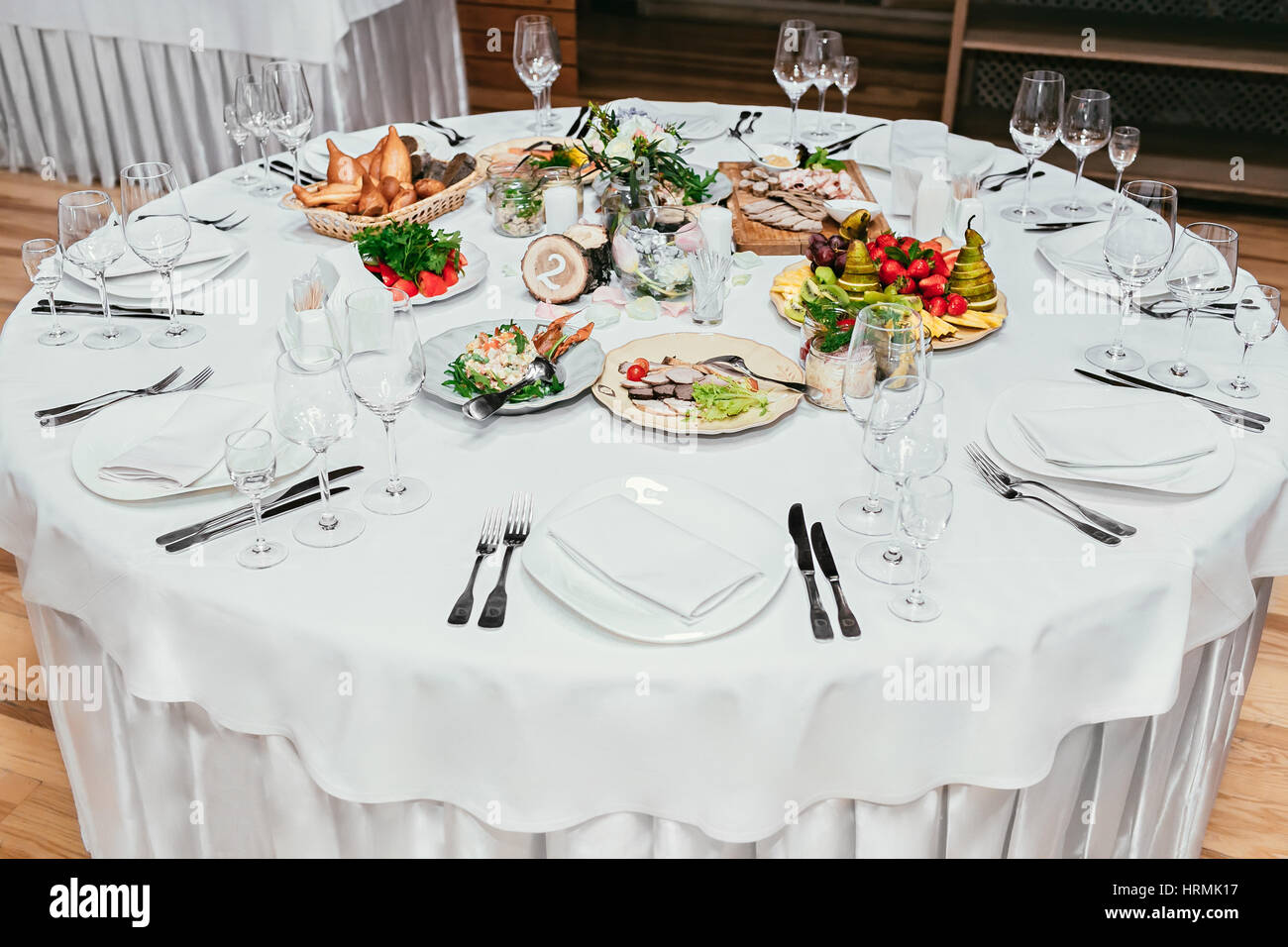 Round restaurant white table with white chairs on wooden floor served ...