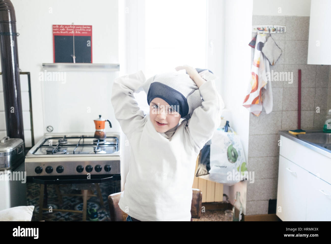 child takes off sweater at home Stock Photo - Alamy