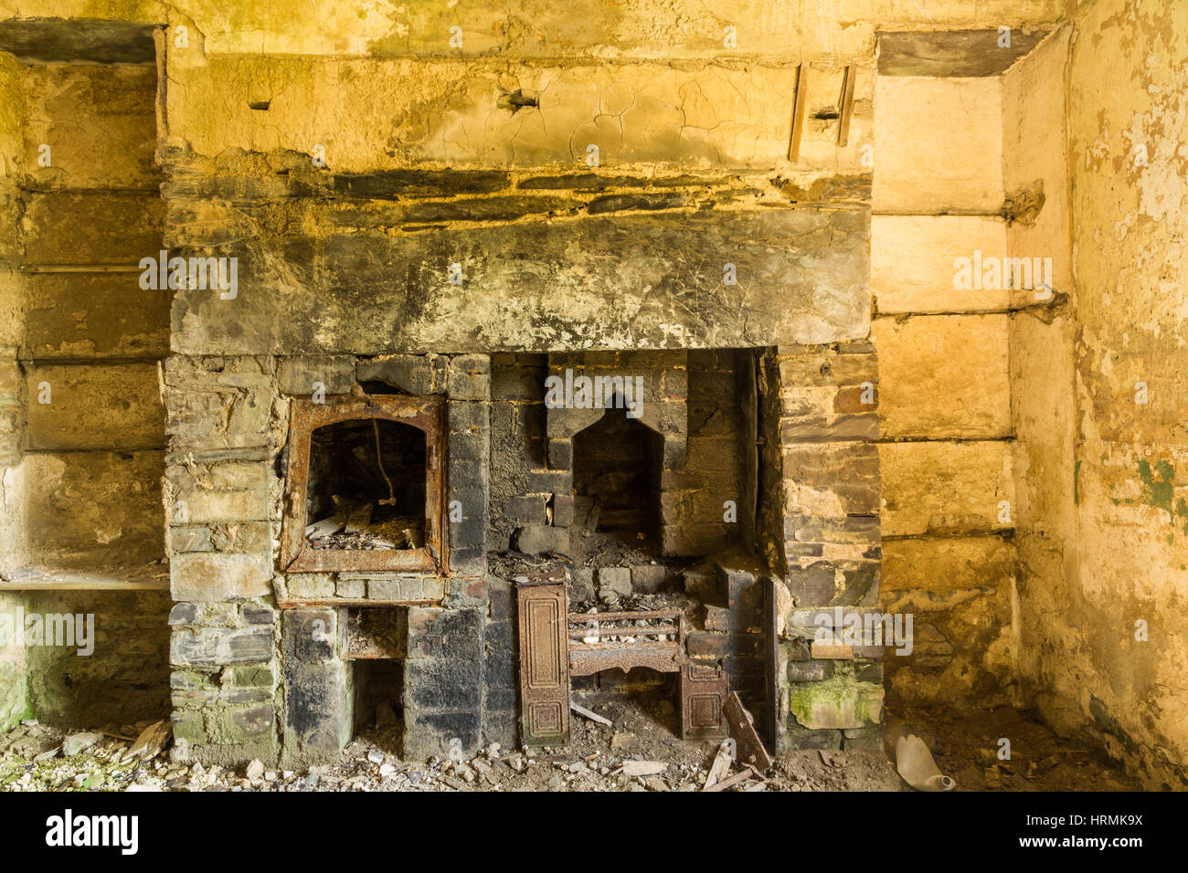 Interior of derelict building with fireplace and peeling walls Stock ...