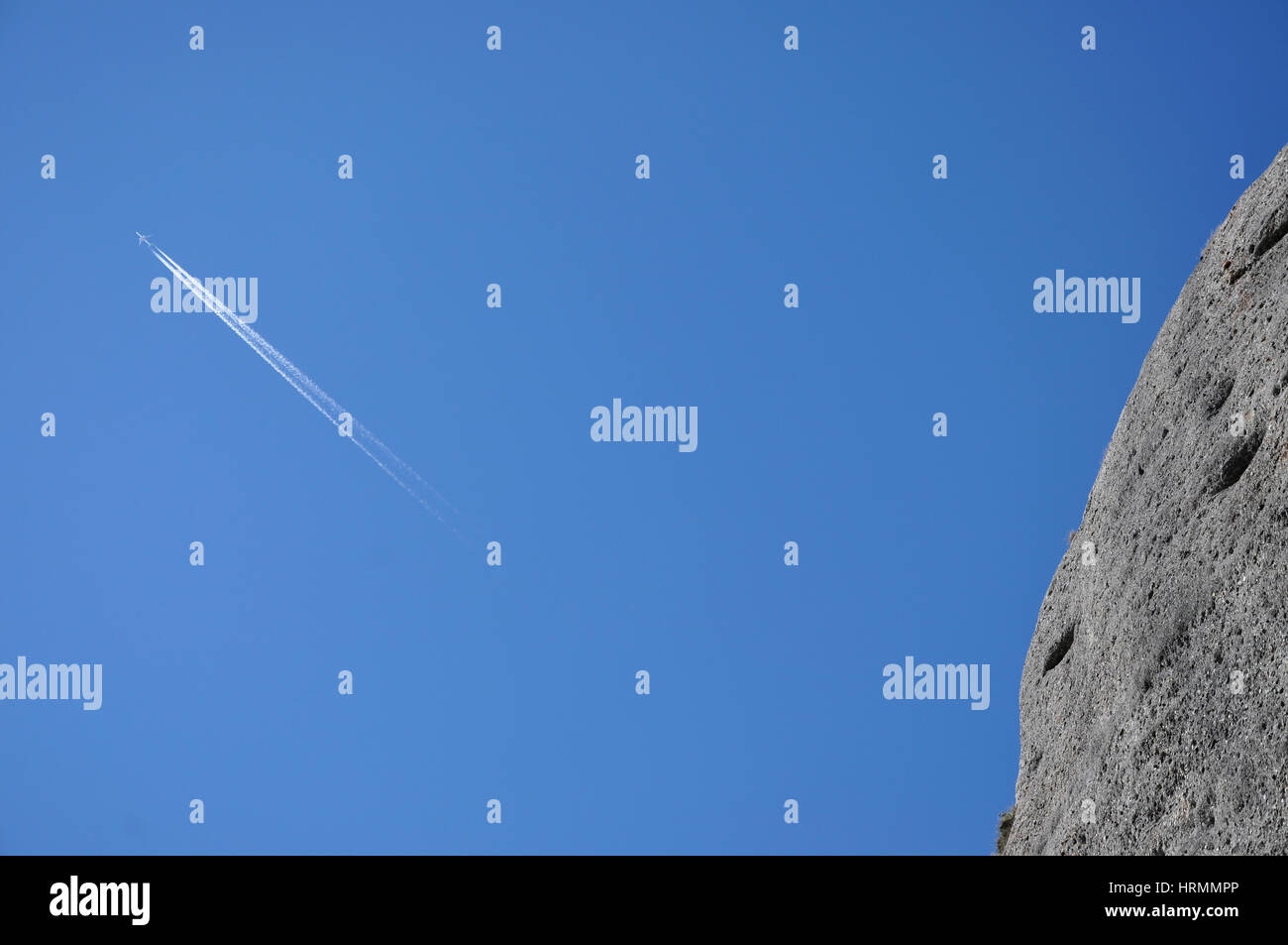 Airplane trace on blue sky Stock Photo - Alamy