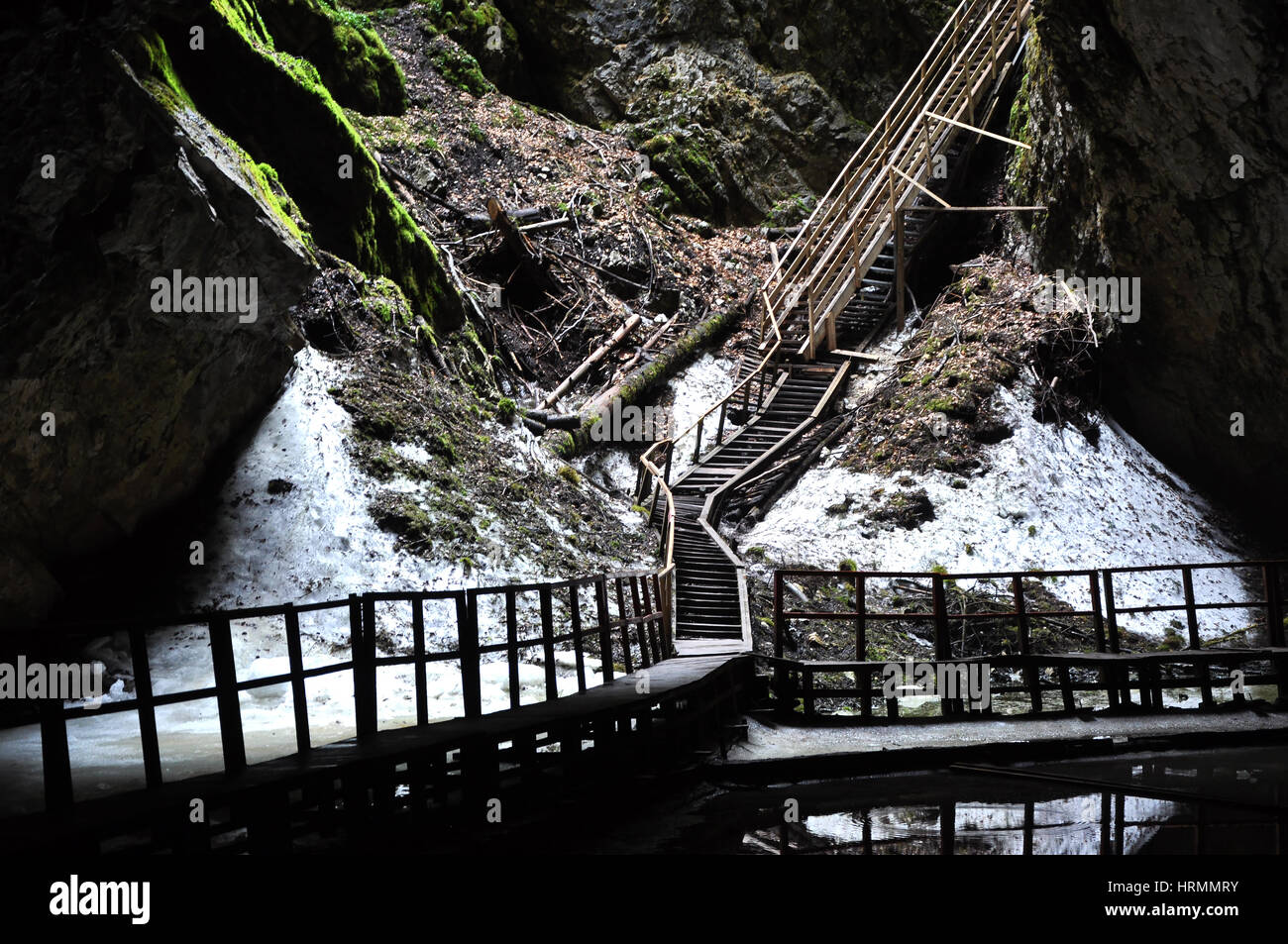 Descending wooden ladder to a deep ice cave. Scarisoara, Romania Stock ...