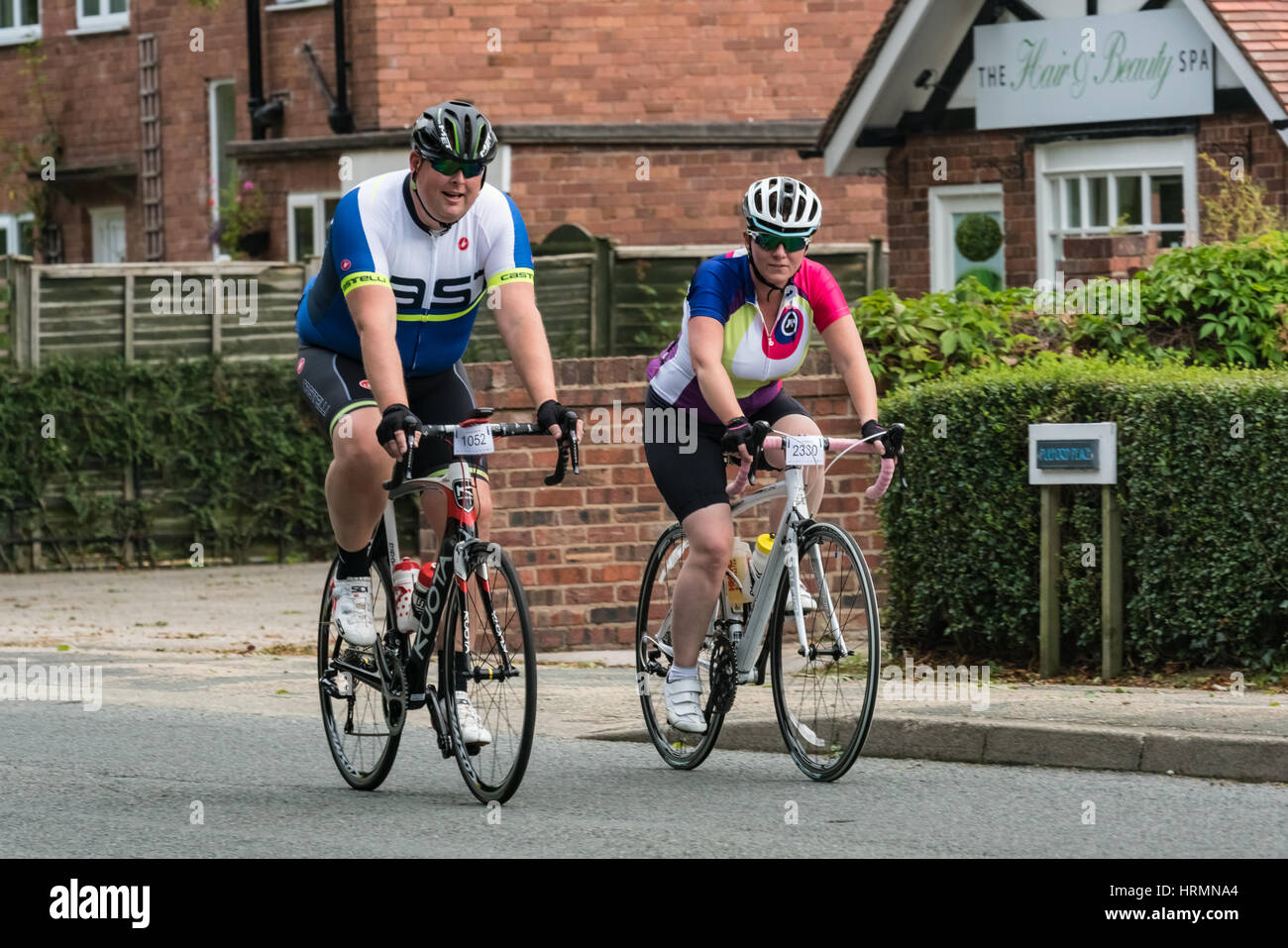 A pair of cyclists on the Rise Above sportive riding through Pulford ...