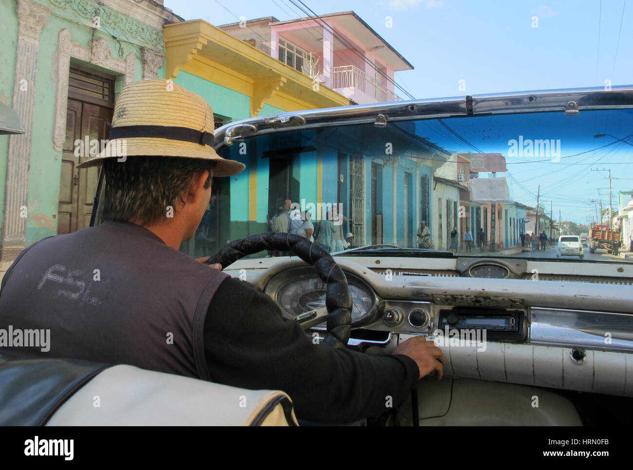 A taxi driver driving a cabriolet on Calle Jesus Maria in Trinidad ...