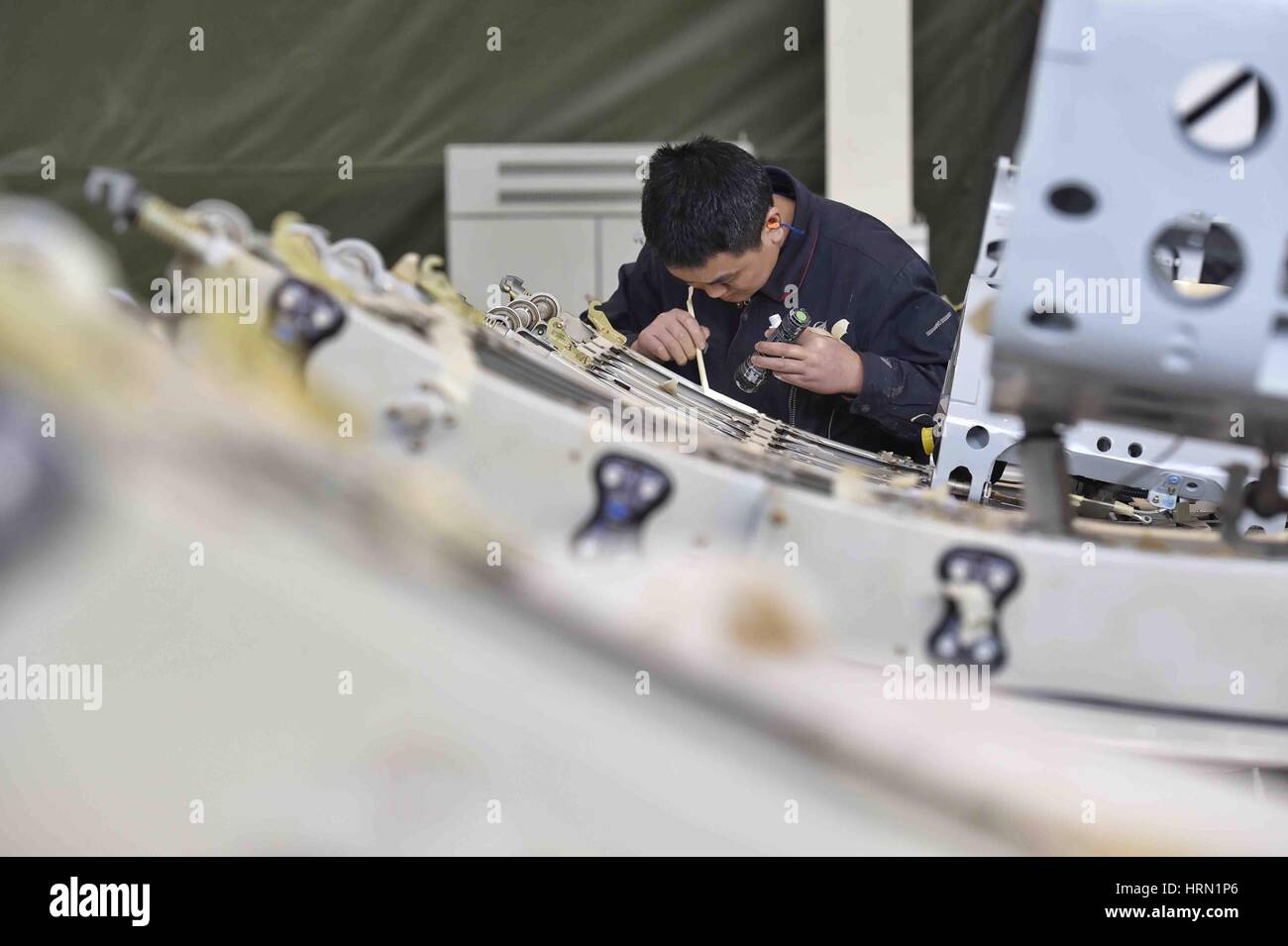 Chengdu, China's Sichuan Province. 3rd Mar, 2017. A man works at the ...