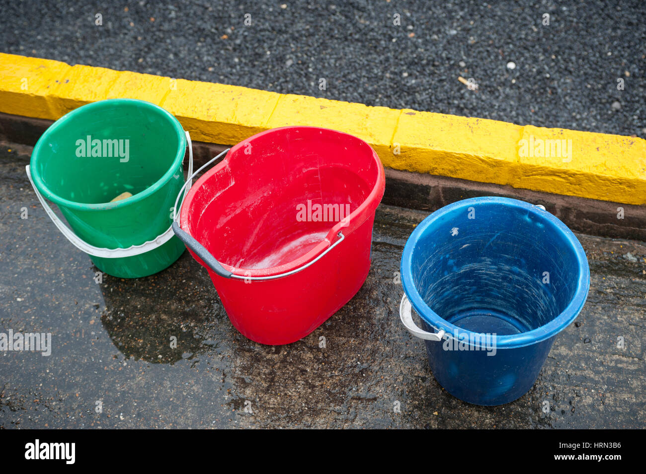 Colourful buckets in a row Stock Photo - Alamy