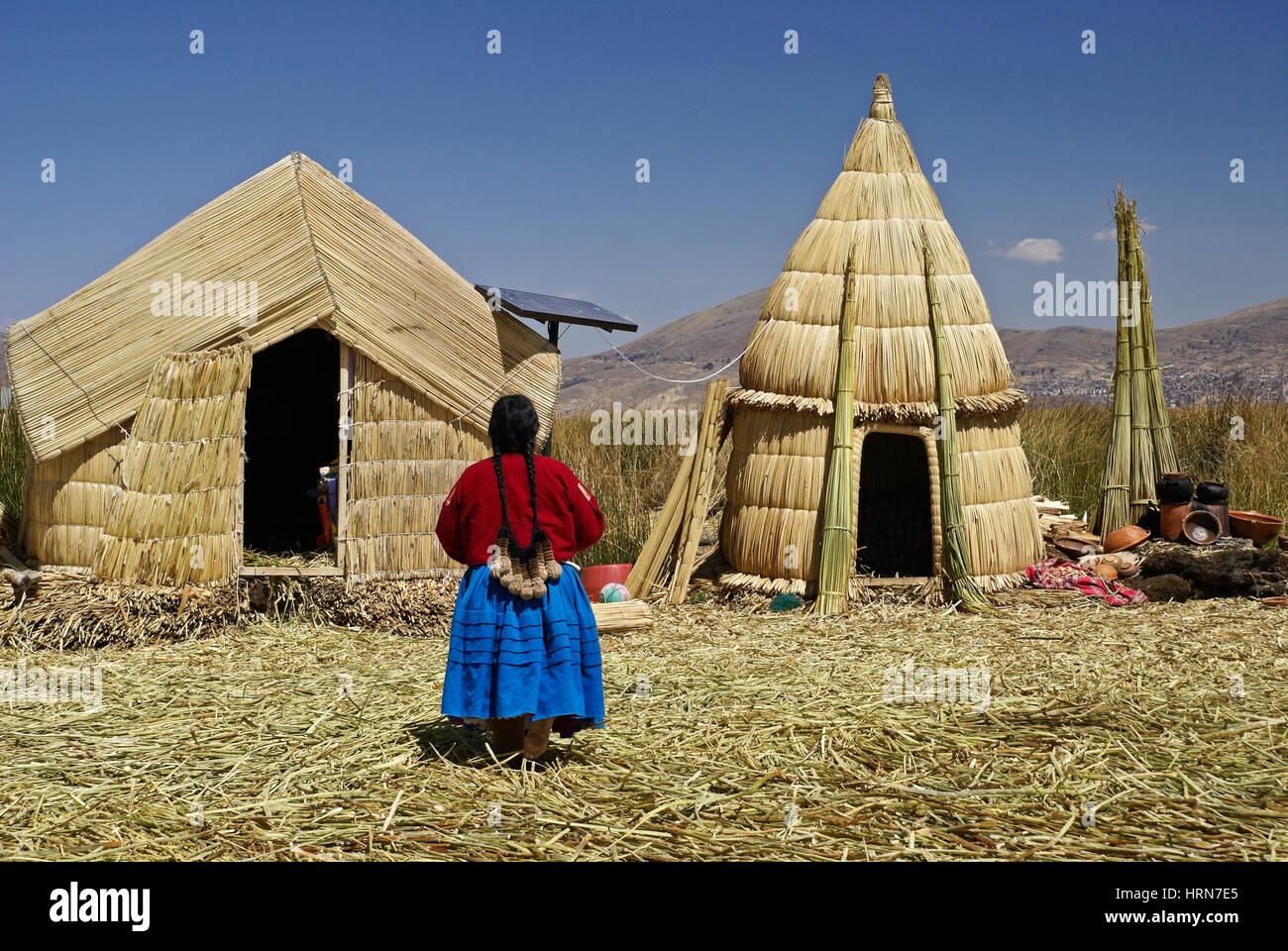 Uros Indian woman and huts (electricity supplied by solar panel) made ...