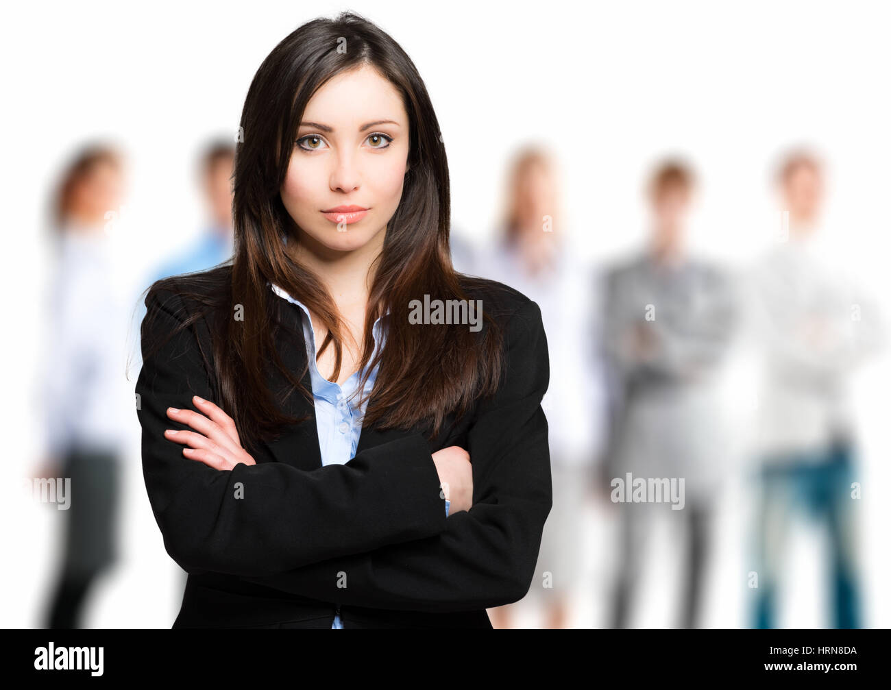 Beautiful female leader in front of her team Stock Photo - Alamy