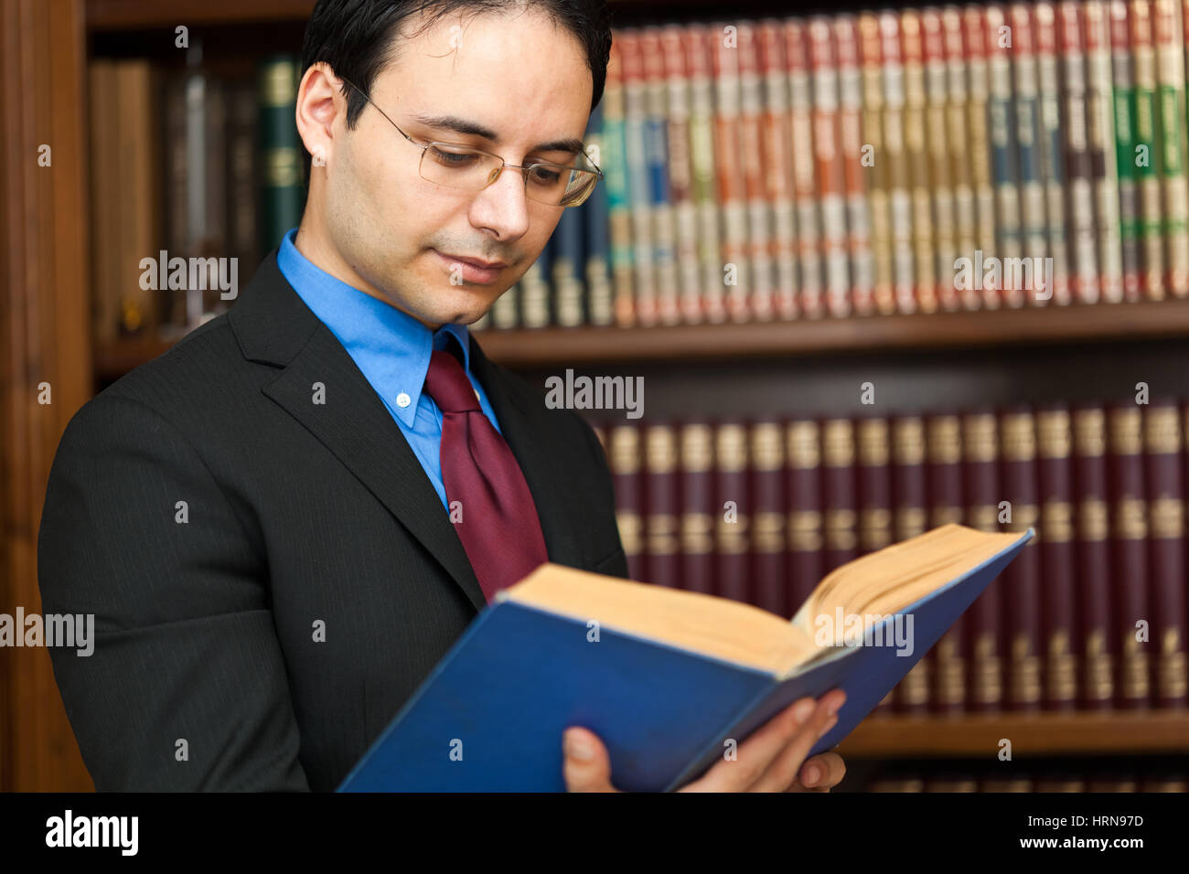Handsome lawyer reading a book Stock Photo - Alamy