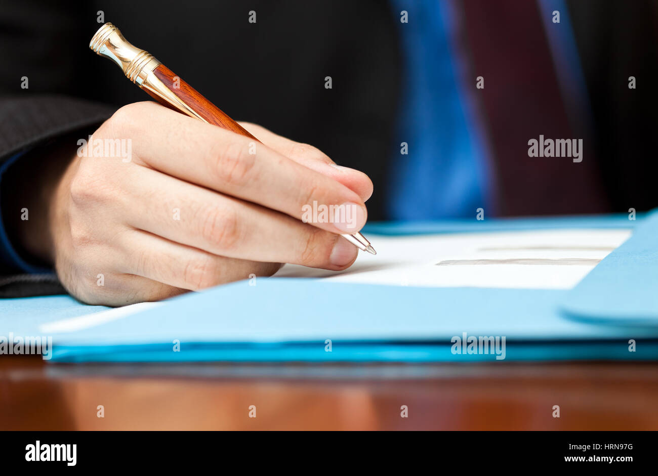 Closeup of a businessman's hands while writing some documents Stock ...