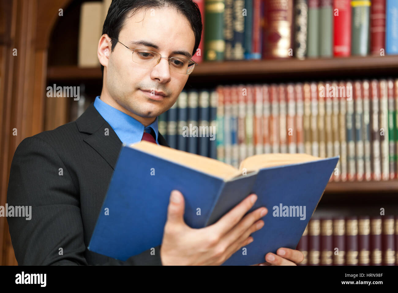 Successful lawyer reading a book Stock Photo - Alamy