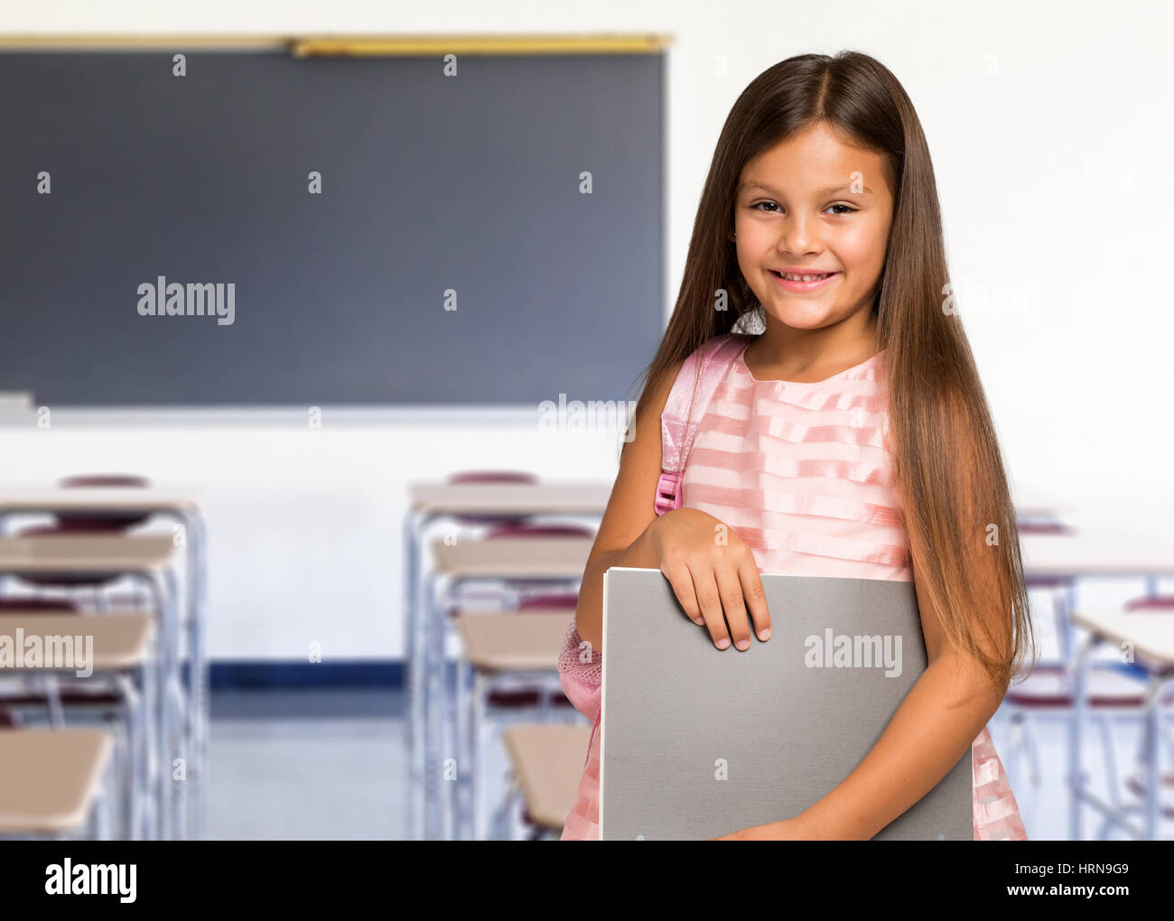 Portrait of lovely girl in classroom Stock Photo - Alamy
