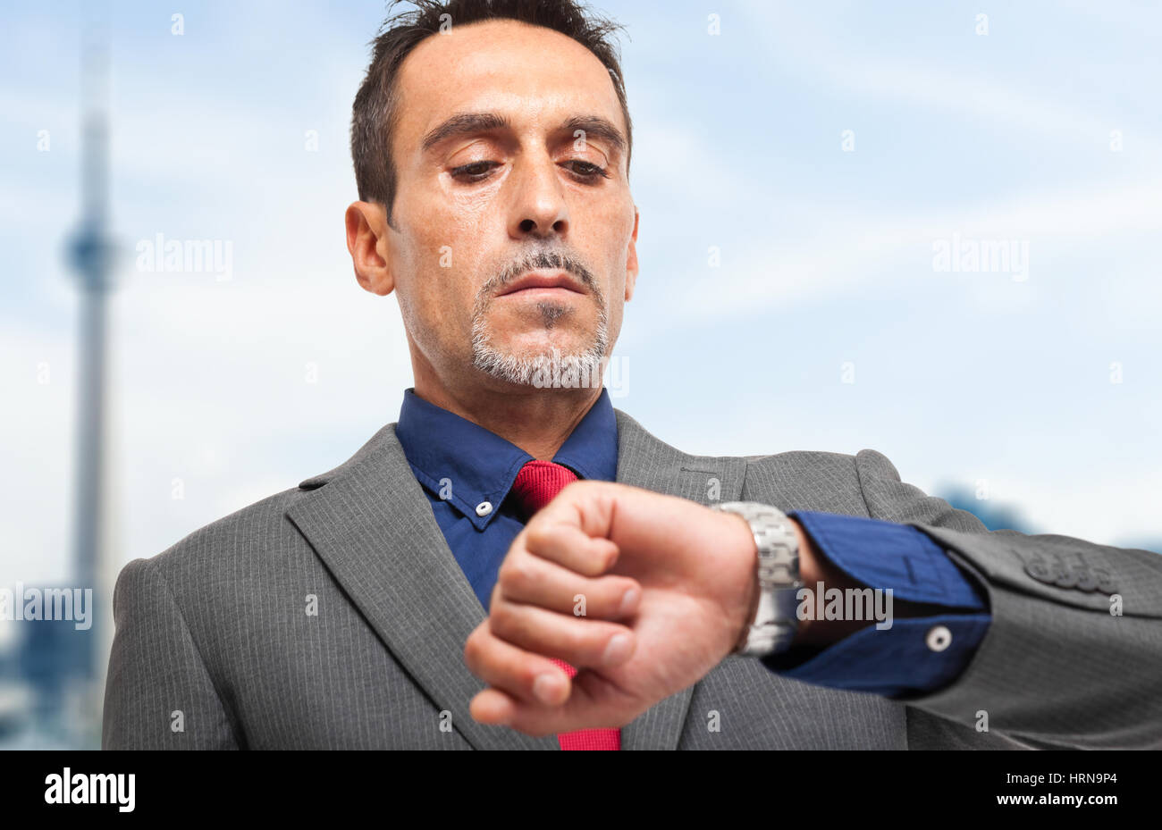 Man checking the time on his clock Stock Photo - Alamy