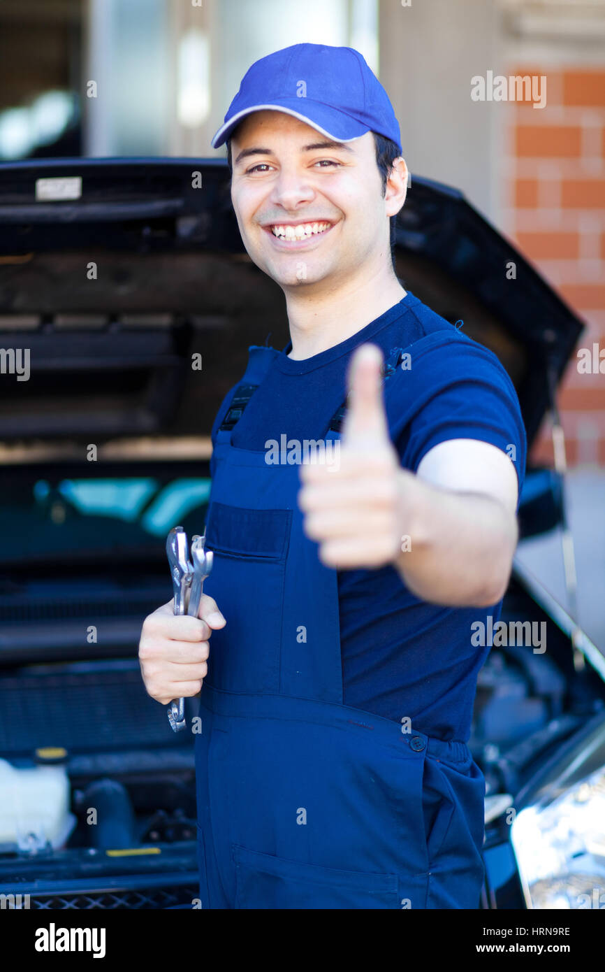 Smiling mechanic thumbs up Stock Photo - Alamy