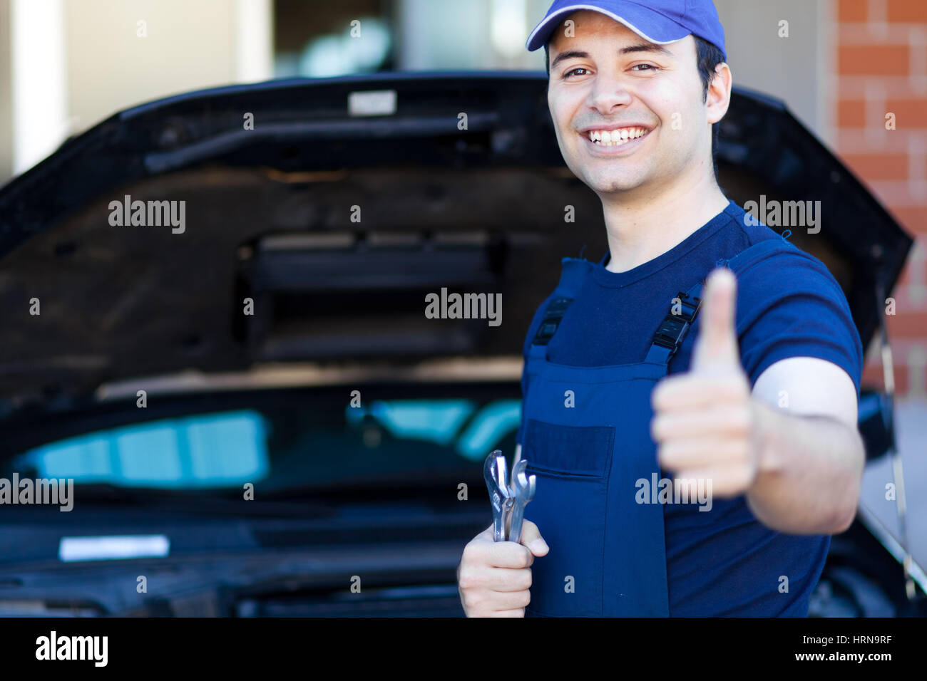 Smiling mechanic thumbs up Stock Photo - Alamy