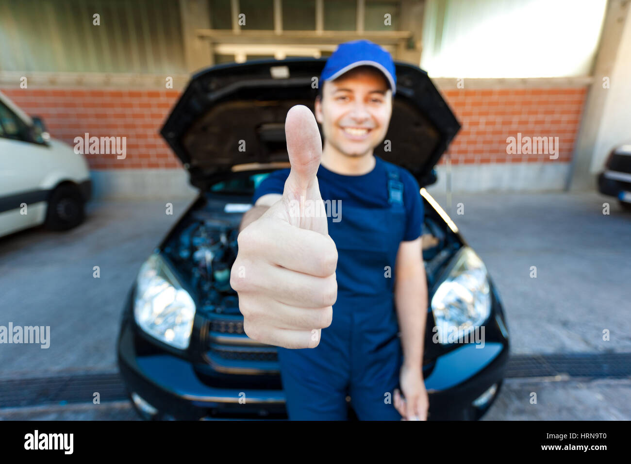 Smiling mechanic thumbs up Stock Photo - Alamy