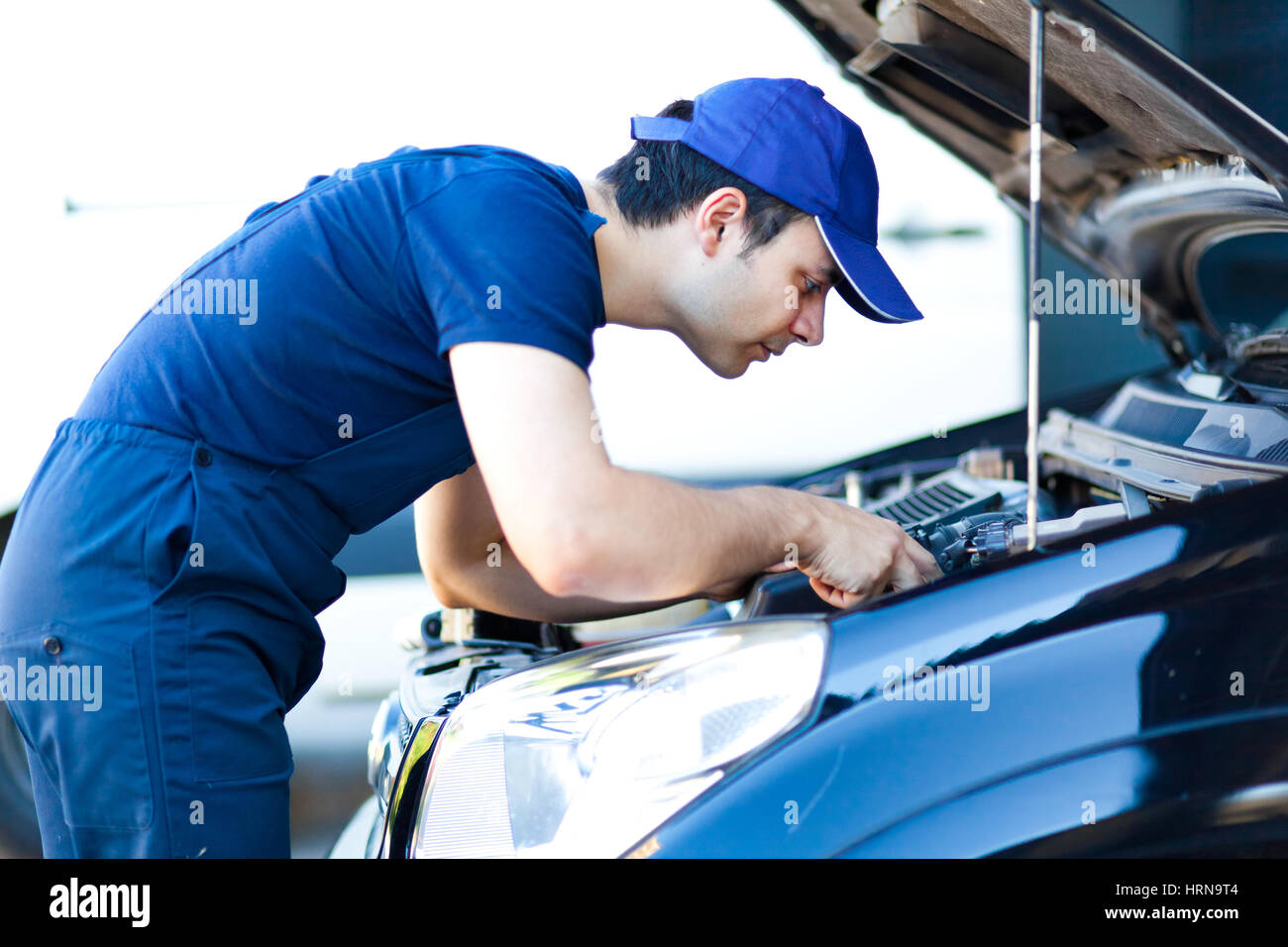 Mechanic fixing a car engine Stock Photo - Alamy