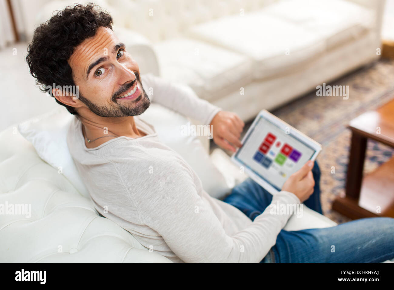 Young man using a digital tablet Stock Photo - Alamy