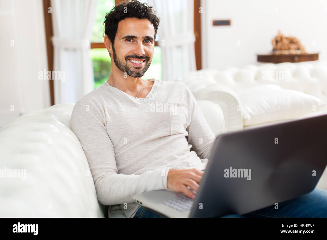 Man relaxing with his laptop Stock Photo - Alamy