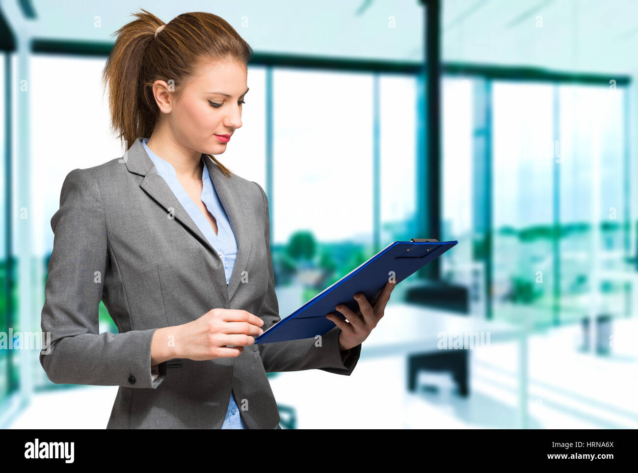 Smiling young female manager Stock Photo - Alamy