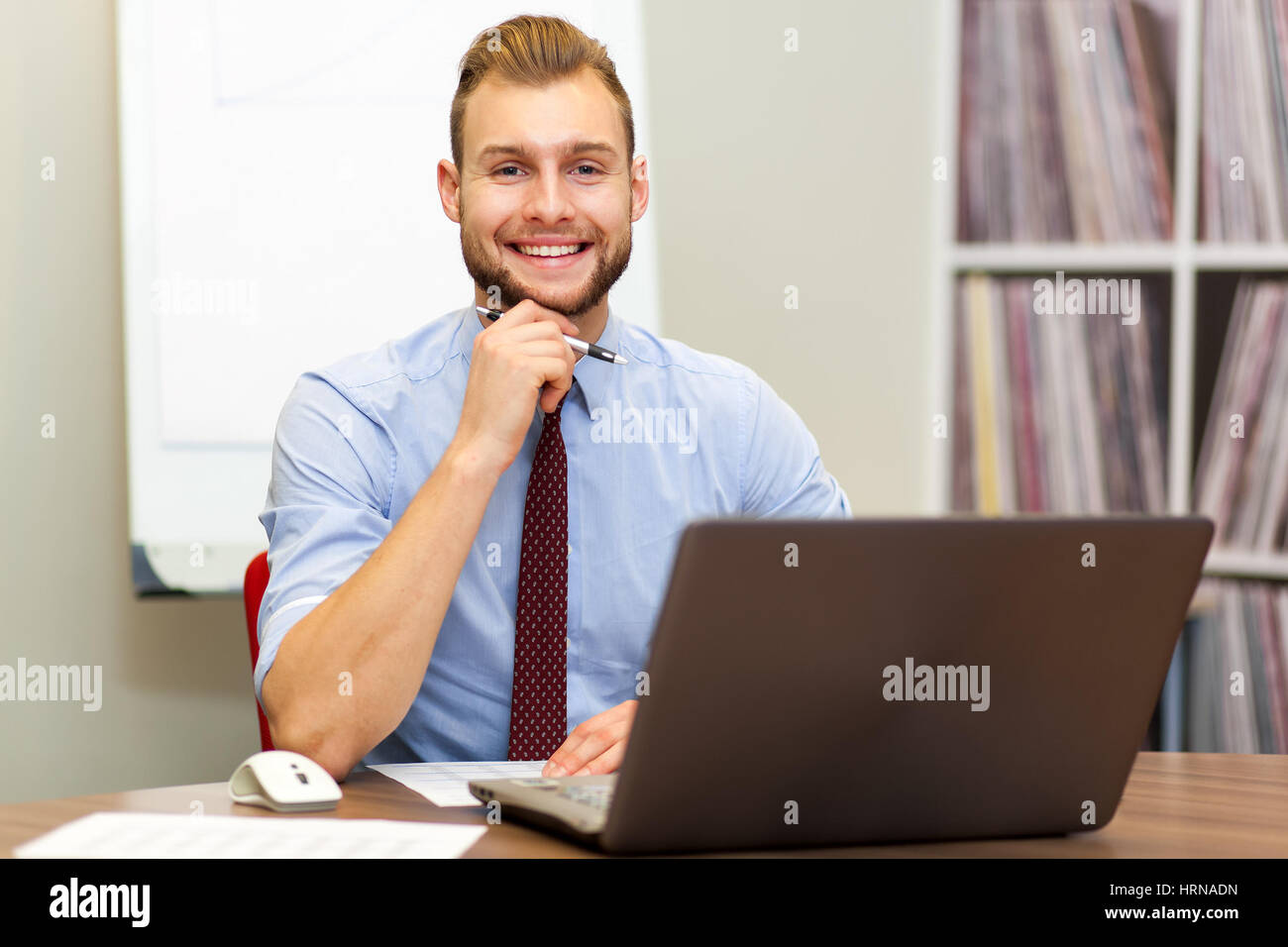 Handsome businessman at his desk in the office Stock Photo - Alamy