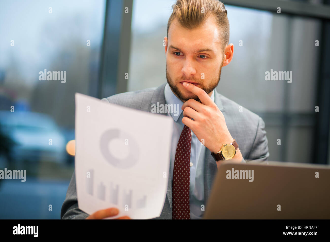 Portrait of a businessman reading a document Stock Photo - Alamy
