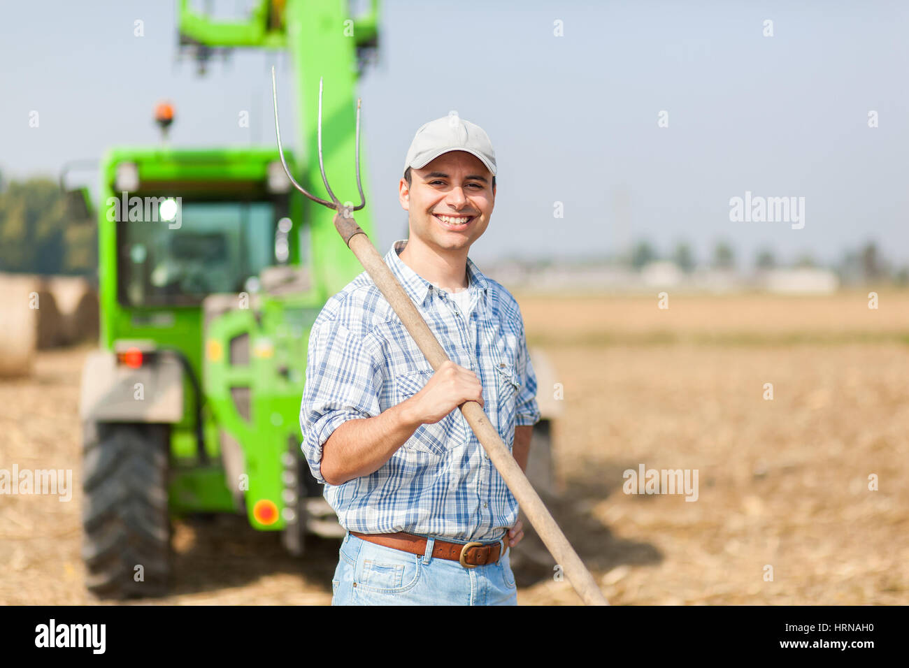 Farmer holding a pitchfork Stock Photo - Alamy